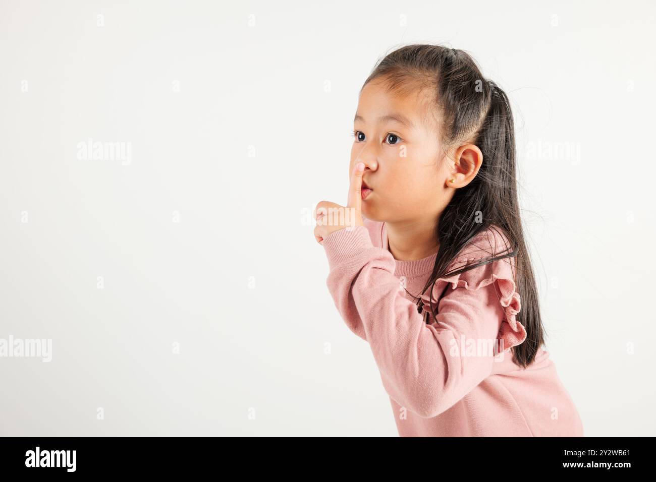 Young kid girl making finger on lips mouth silent quiet gesture, Happy ...
