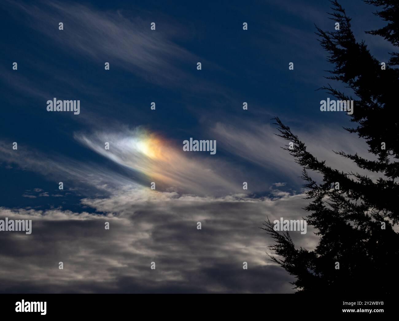 A beautiful sky with a subtle rainbow effect in the clouds and ...