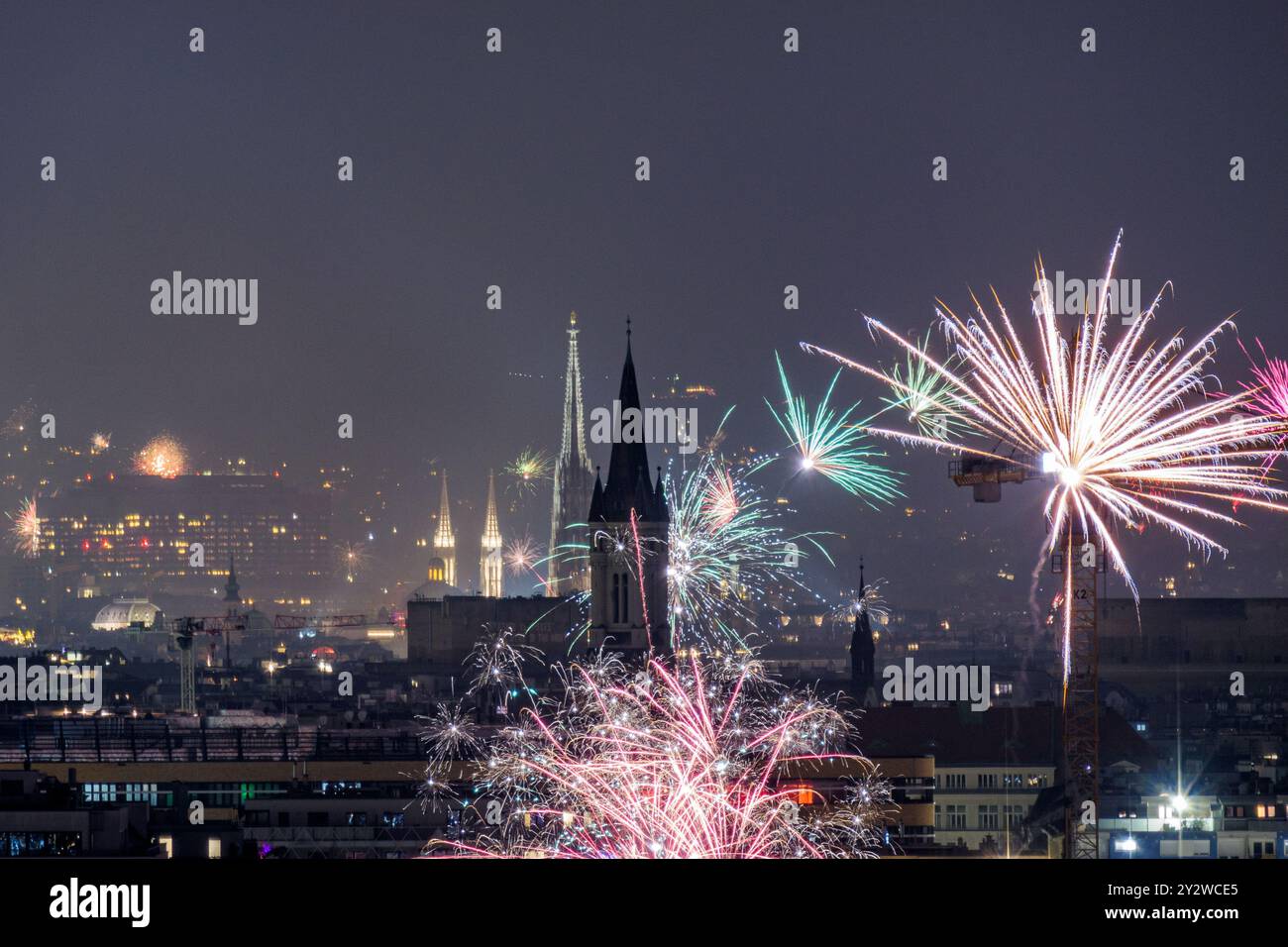 A stunning display of fireworks over a city skyline with illuminated ...