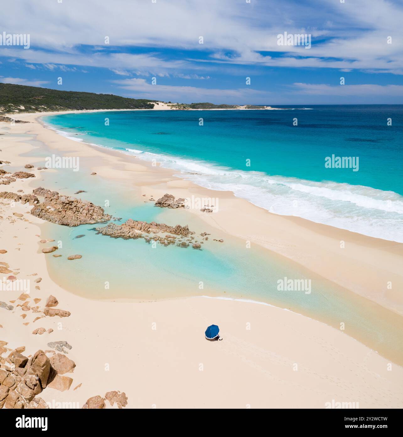 An aerial view of a pristine beach with turquoise waters, white sand ...