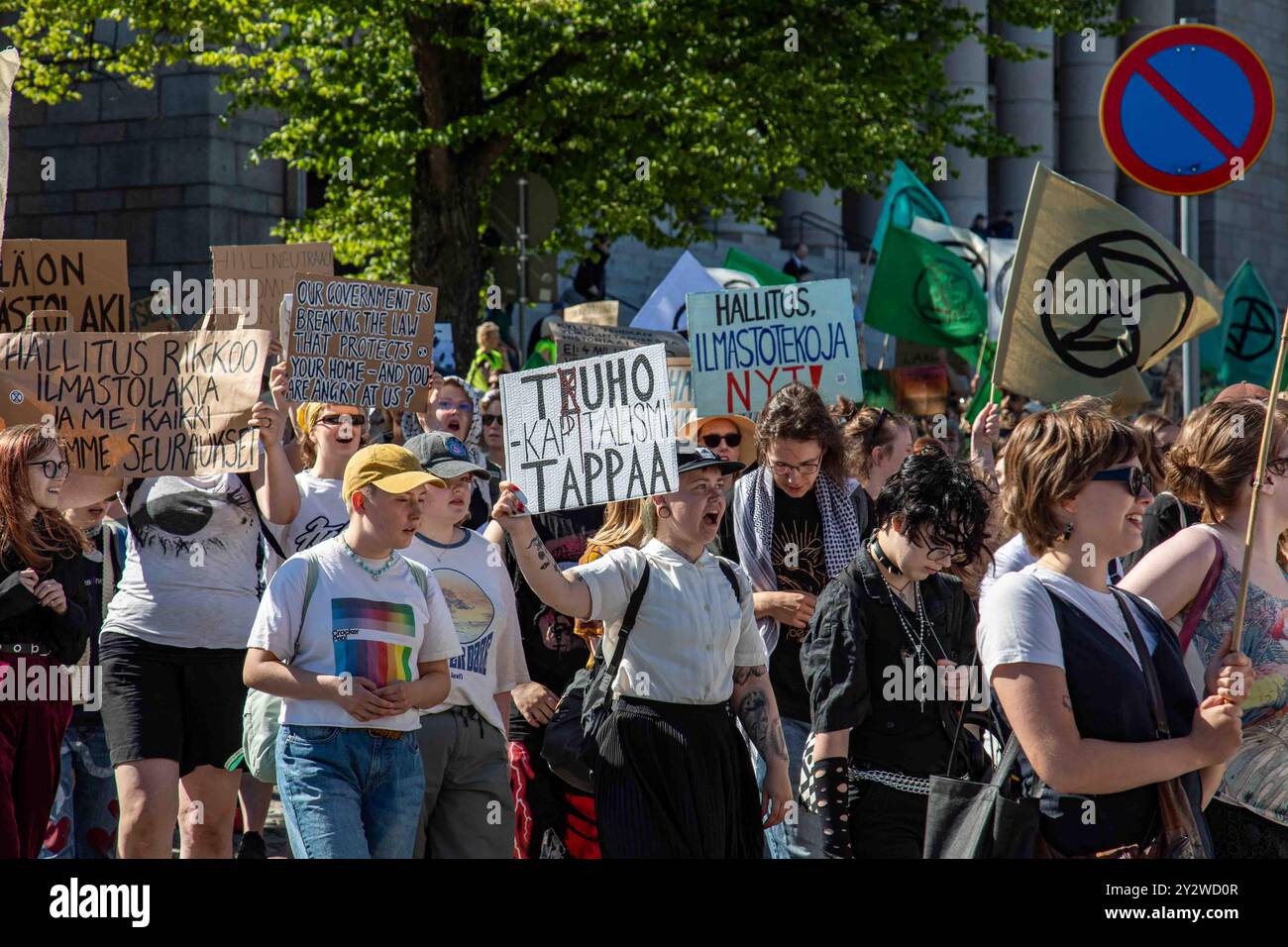 Protesters with flags and cardboard signs marching from Parliament ...