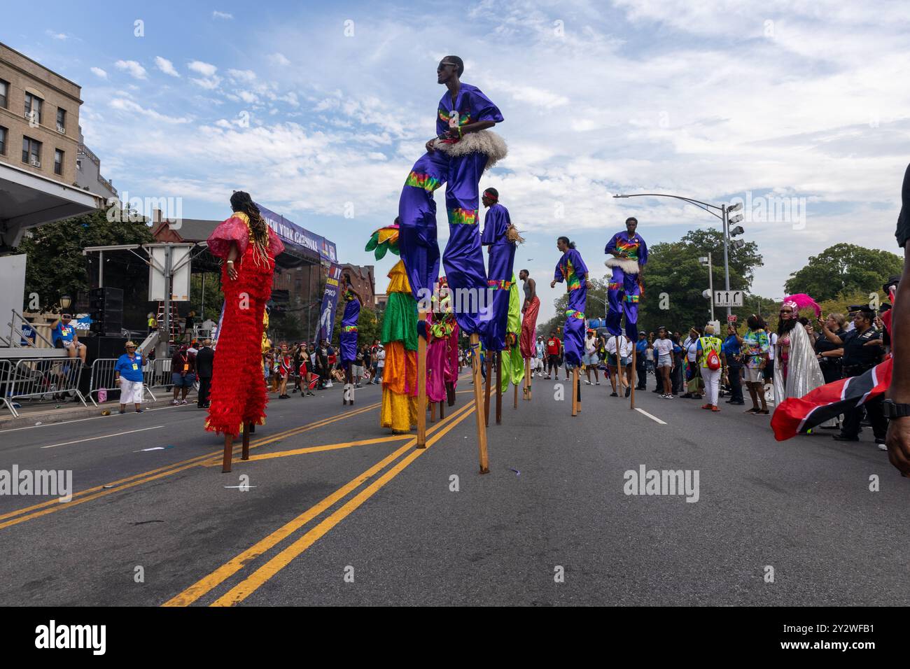 A folklore group with stilts performing in the street during West ...