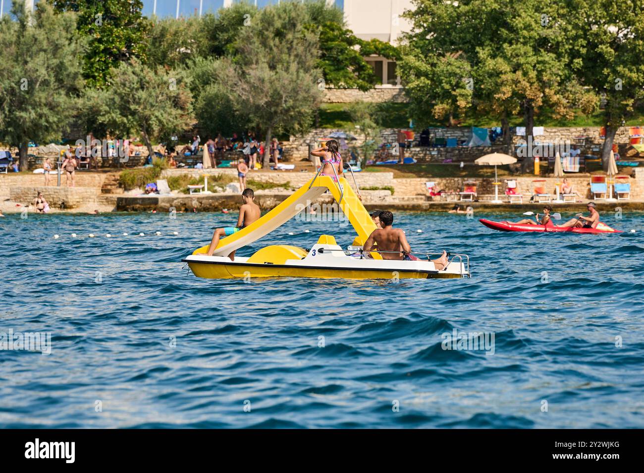 Porec, Istria, Croatia - August 27, 2024: Family enjoys a ride in a ...