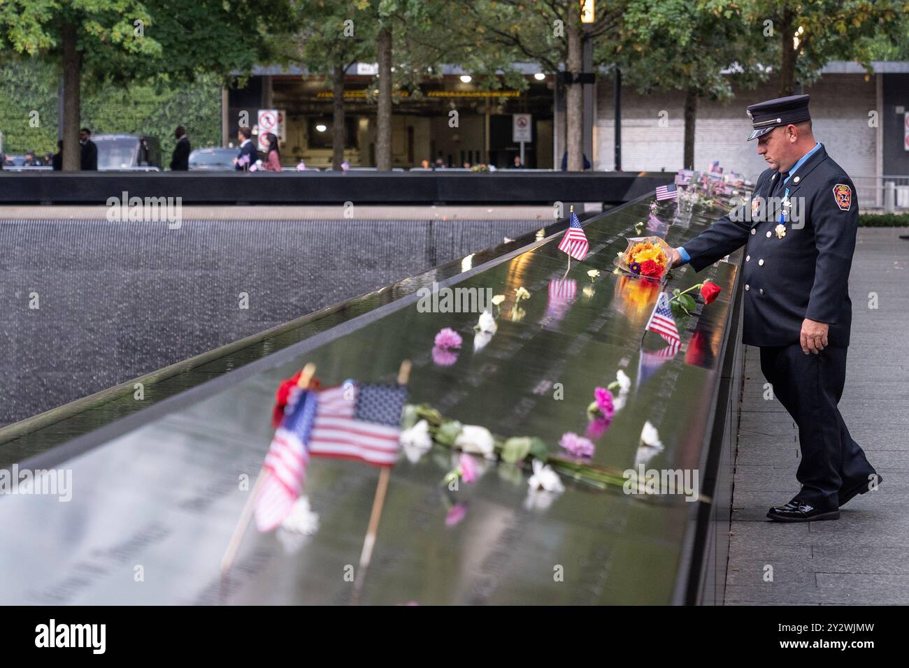 New York, USA. 11th Sep, 2024. A firefighter grieving at the South pool ...