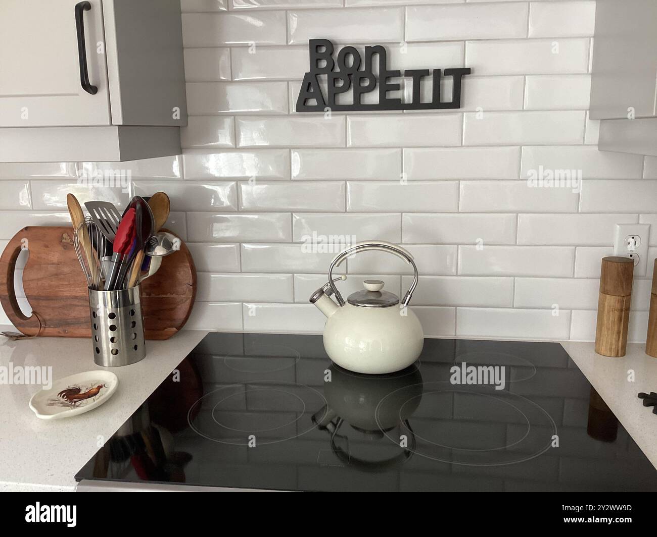 Modern kitchen with white subway tile backsplash, induction cooktop ...