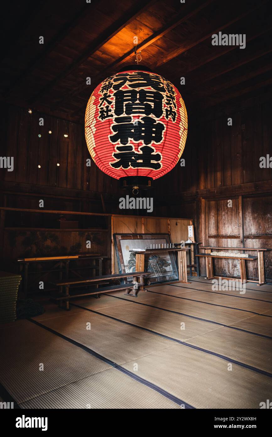 Traditional Japanese room with a large paper lantern hanging from the ...