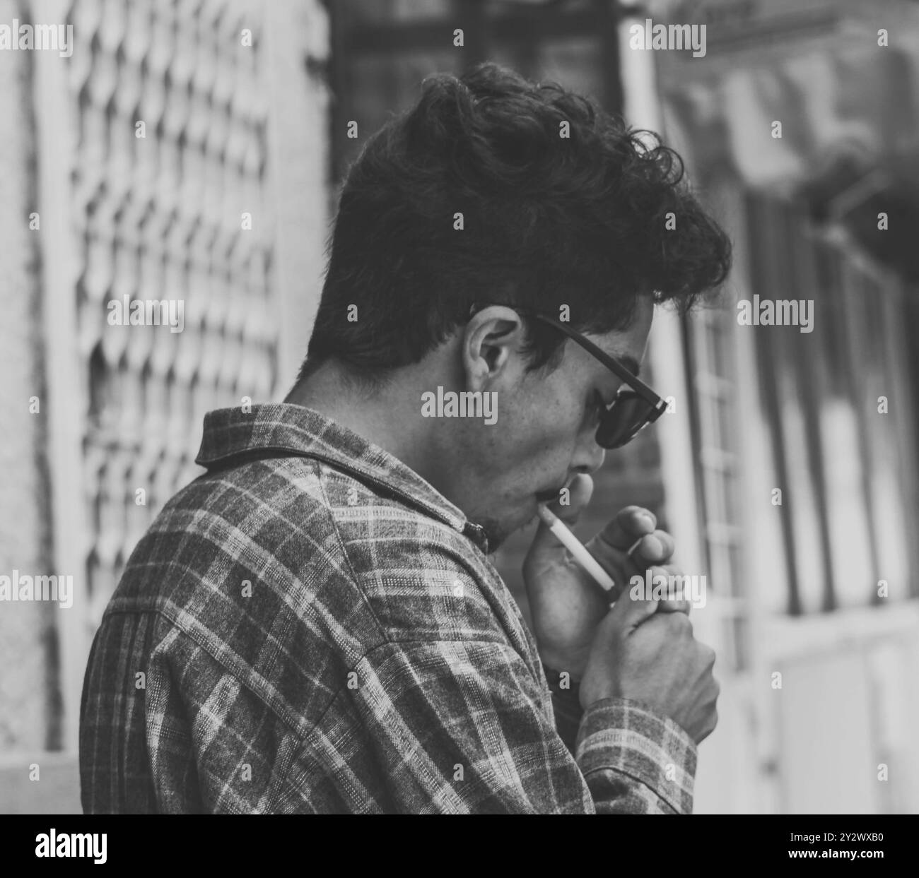 young man smoking in the street with great style Stock Photo - Alamy