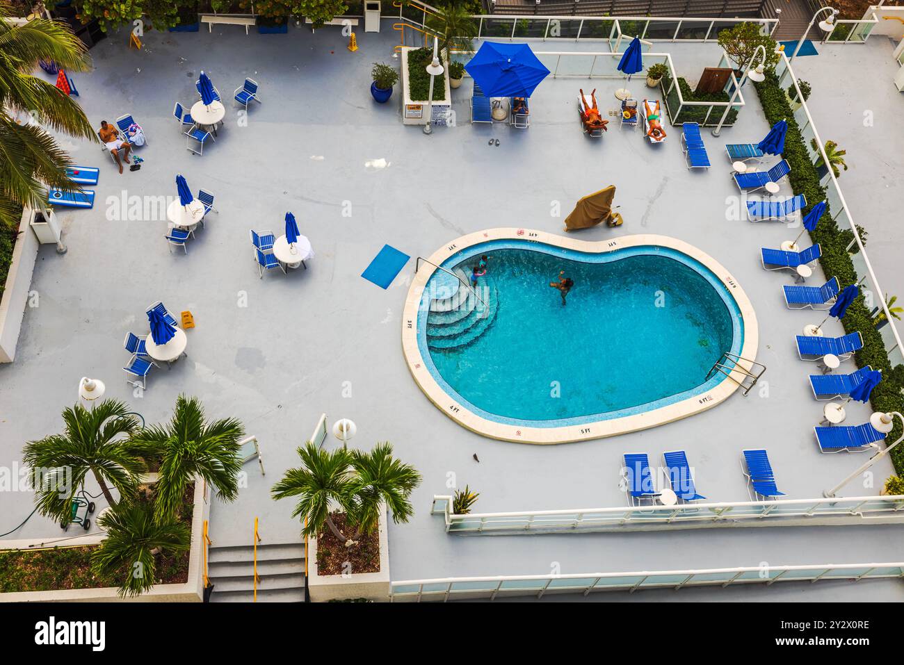 Top-down view of hotel grounds with outdoor swimming pool, sun loungers ...