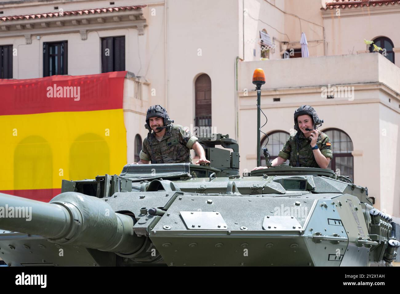 Detail of two smiling tank soldiers peeking out of the hatches of the ...