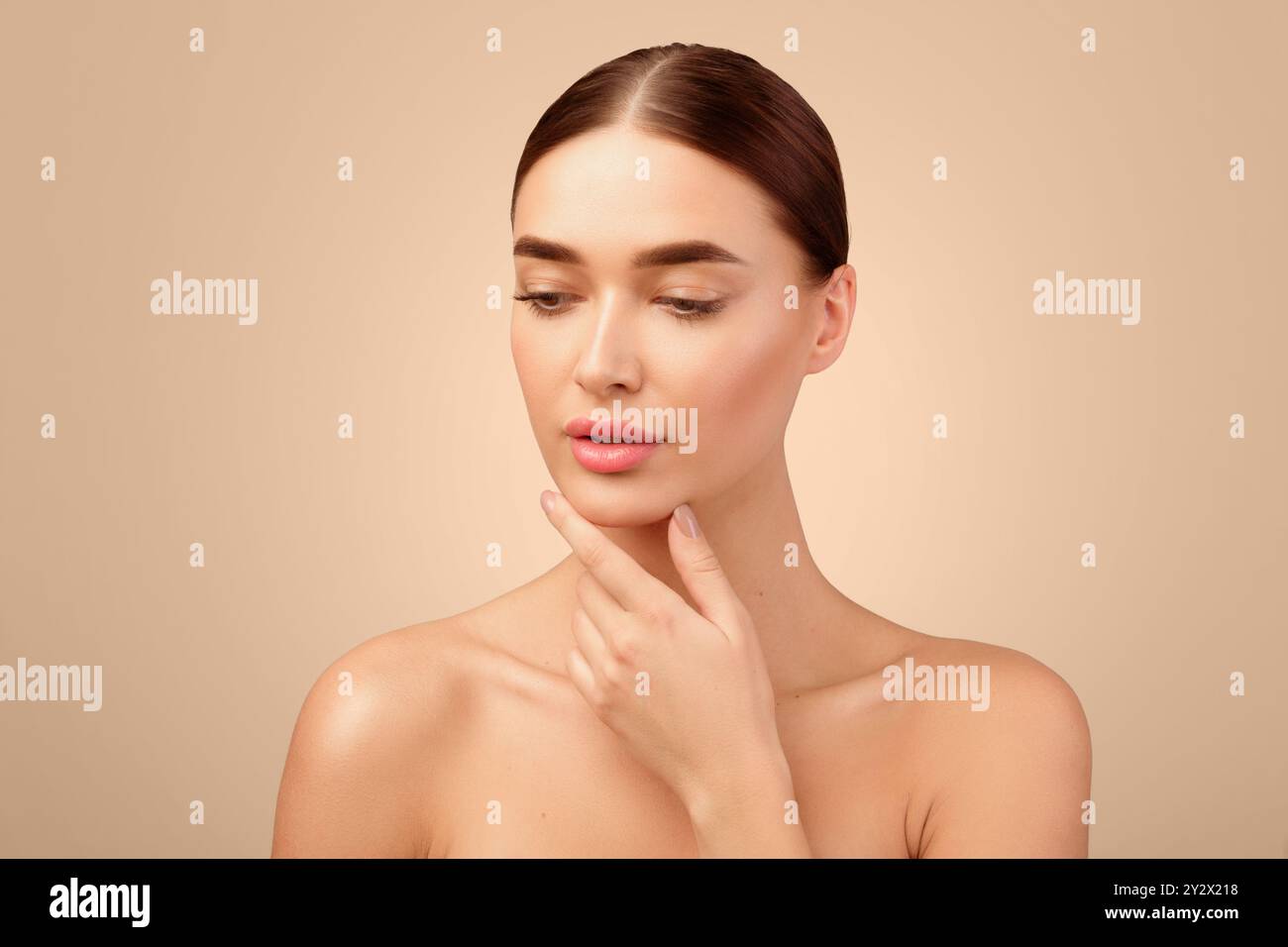 Young European Lady Touching Face And Chin Over Gray Background Stock ...