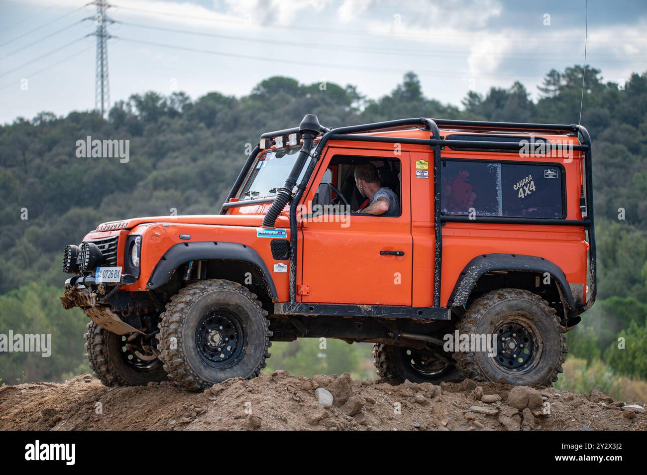Side view of a nice orange Land Rover Defender highly modified for ...