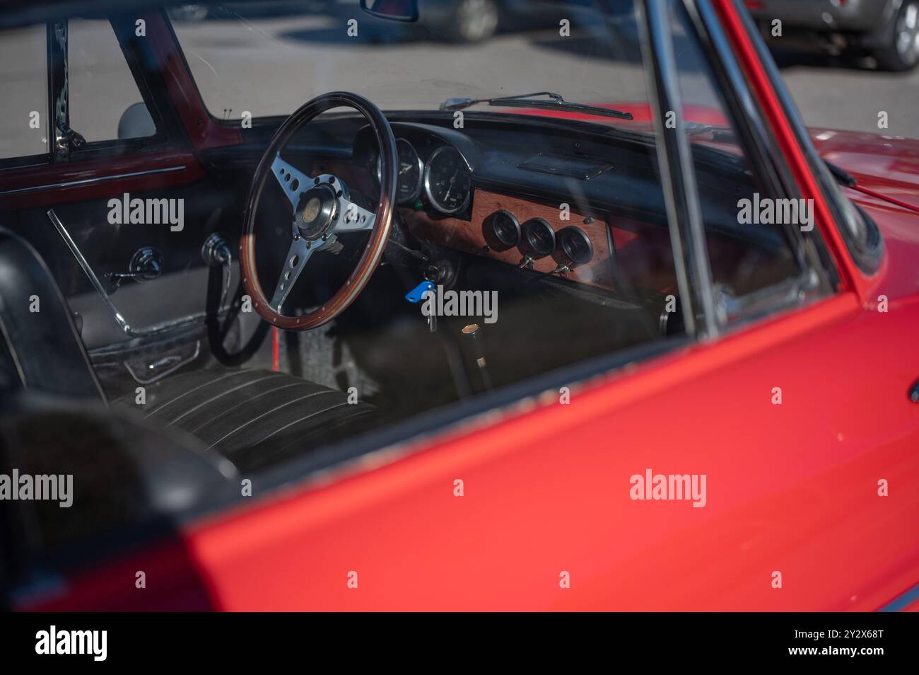 Interior view through the glass of a red classic French convertible ...