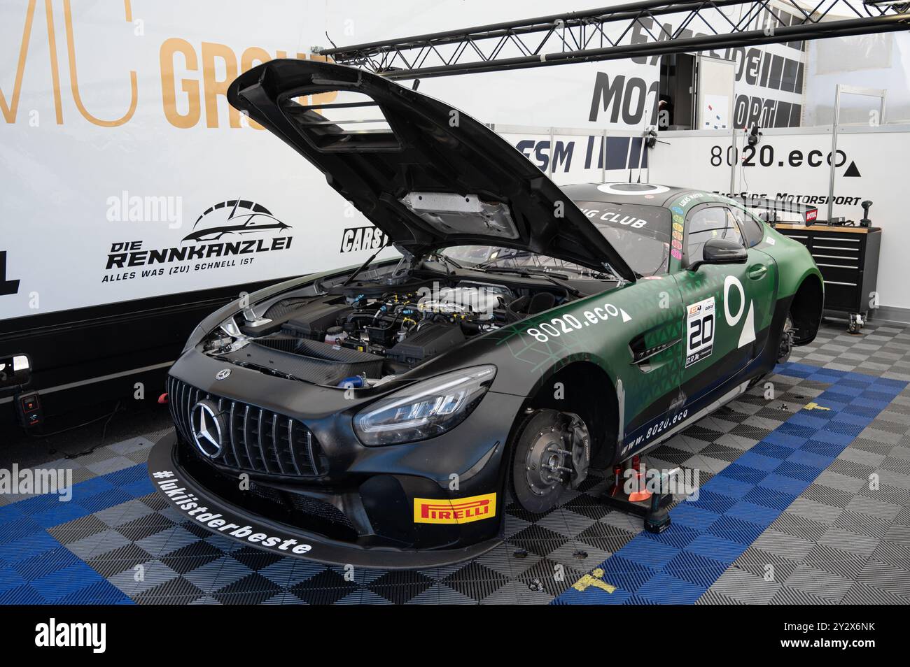 Pit tent of a GT4 European Series racing team. Side view of a Mercedes ...