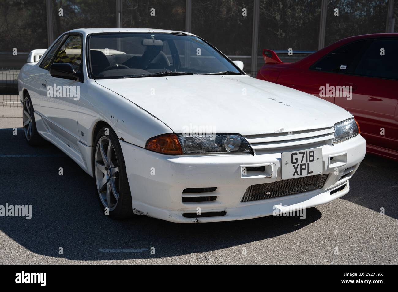 Front view of a white eighth-generation Nissan Skyline GT-R32 at a ...