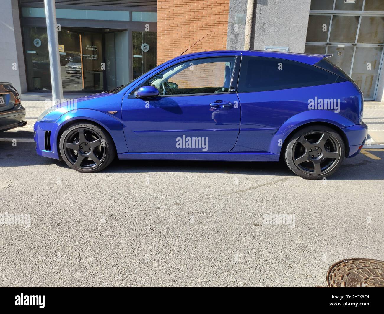 Side view of an impressive and exclusive hatchback sports car, the blue ...