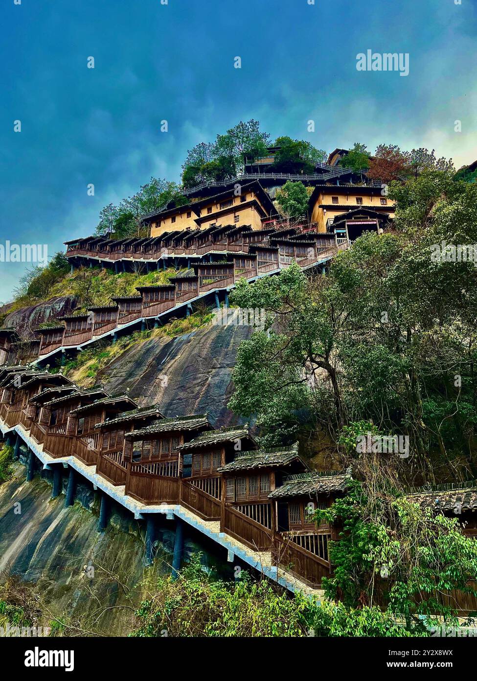A scenic view of a traditional wooden staircase leading up a steep hill ...