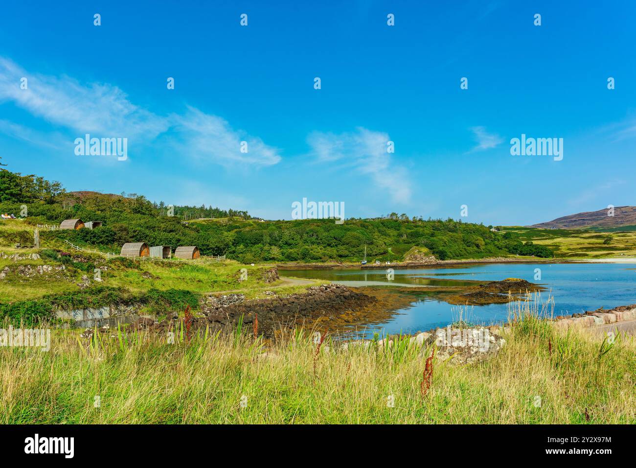 The beautiful Isle of Eigg in Summer with Eigg camping pods overlooking ...