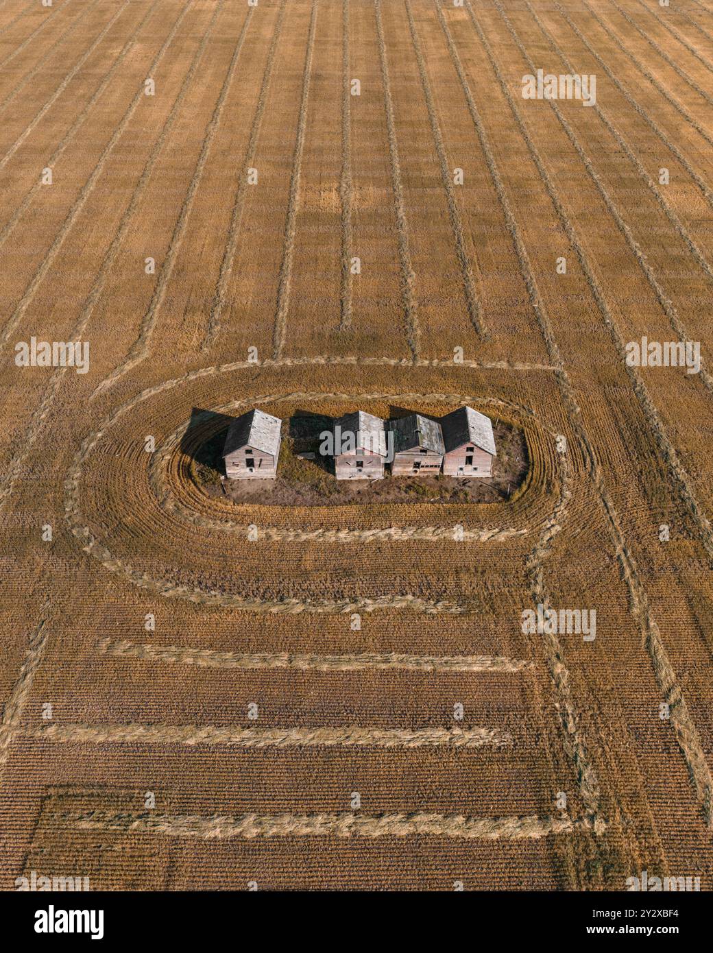 An aerial view of a farm with old buildings surrounded by harvested ...