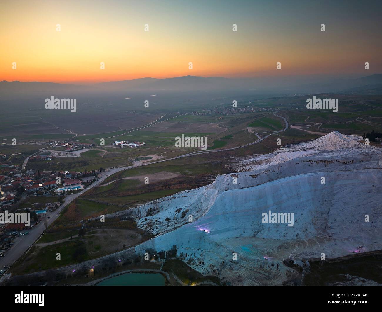 Aerial view of Pamukkale, Turkey at sunset, showcasing the travertine ...