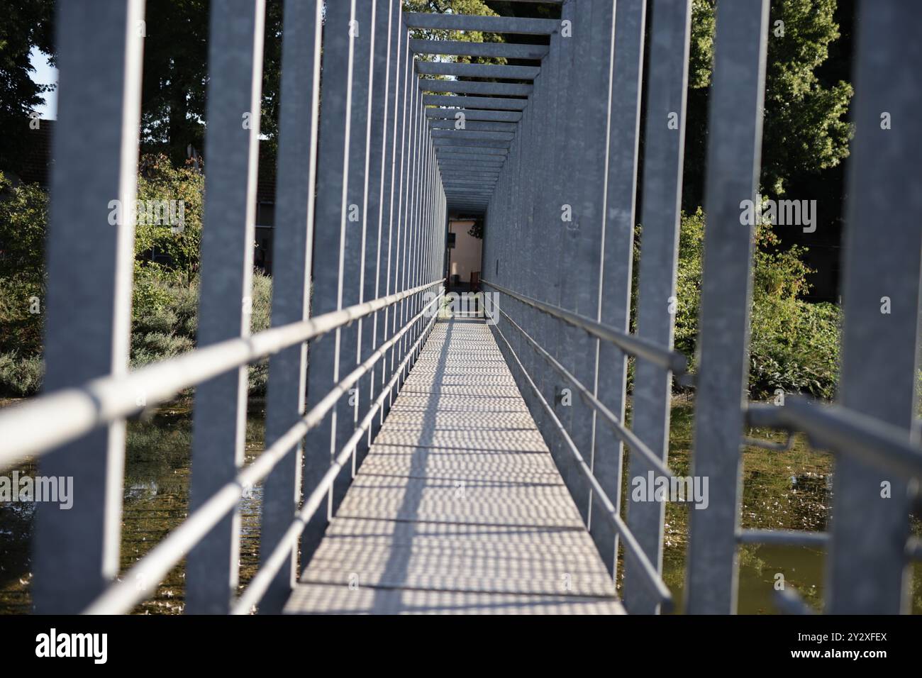 A perspective view of a metal pedestrian bridge with railings ...