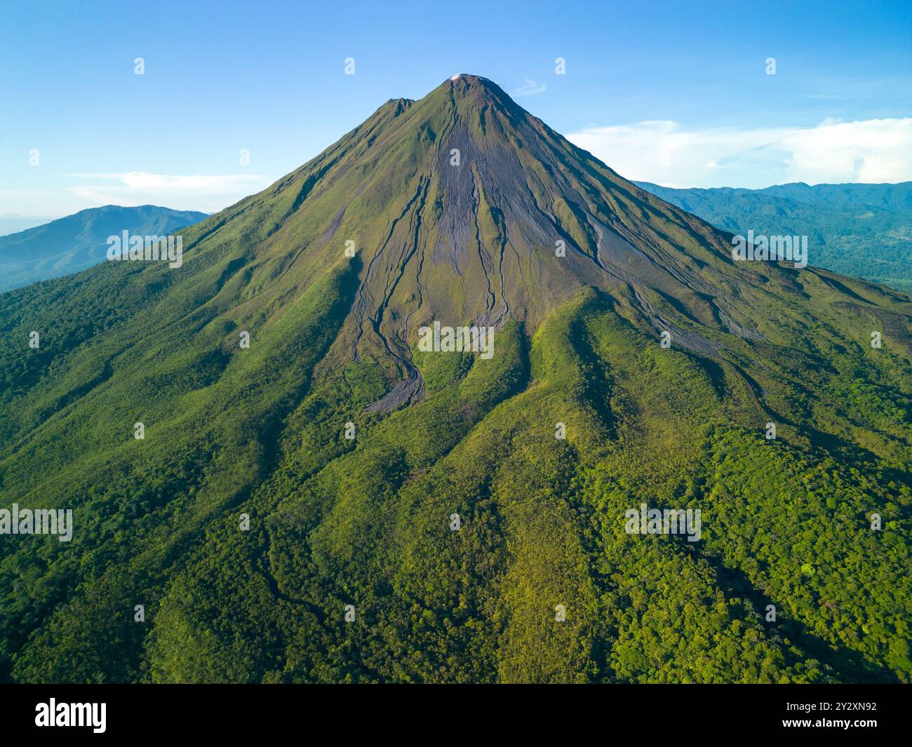 A scenic aerial view of Arenal Volcano in Costa Rica with lush green ...