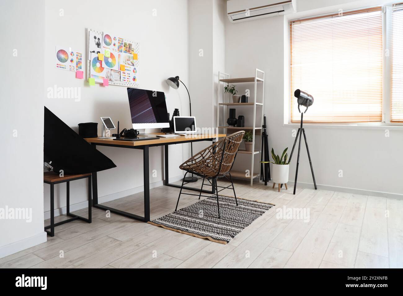 Table with modern computer, photo camera and gadgets in office ...