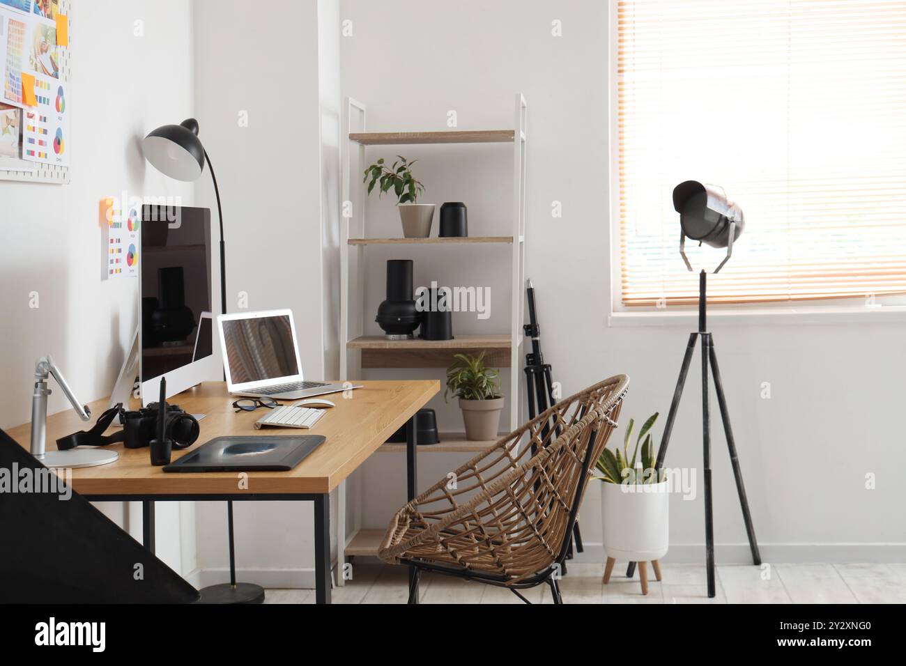 Table with modern computer, photo camera and laptop in office ...