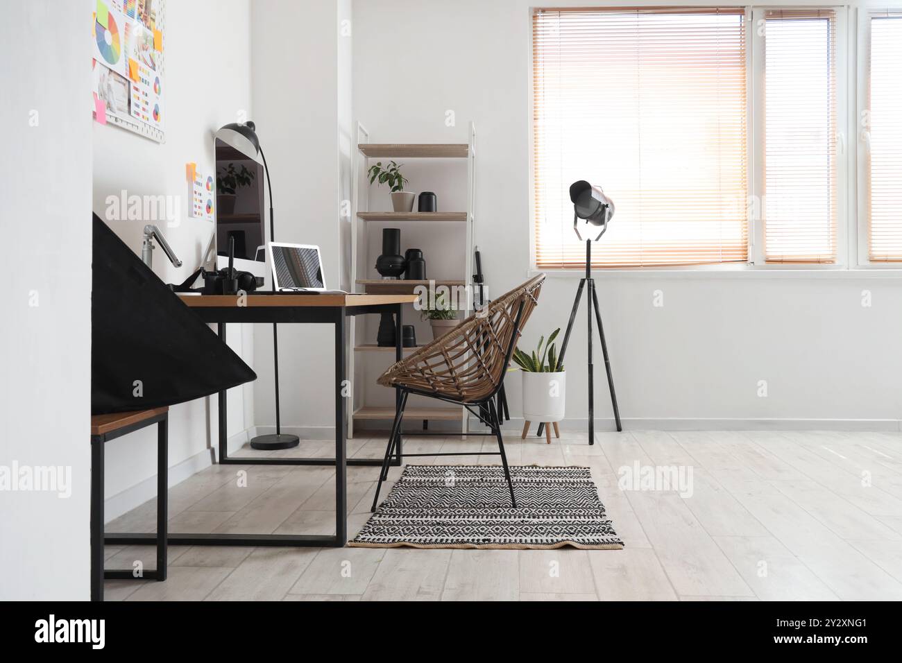 Table with modern computer, photo camera and laptop in office ...