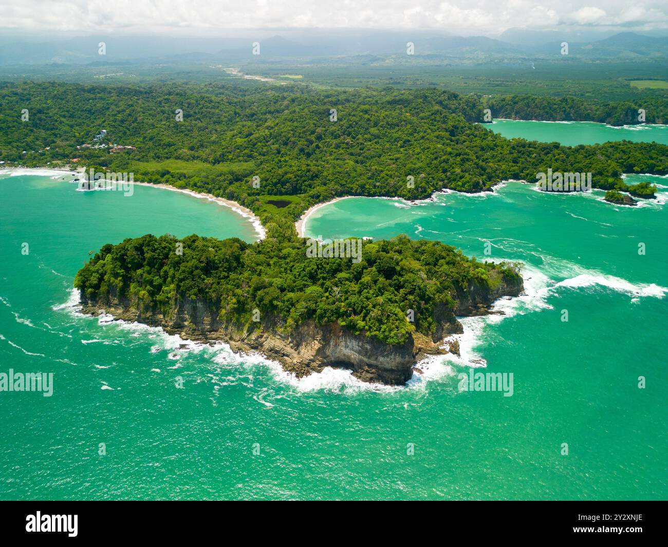 Aerial view of a lush green island surrounded by turquoise waters in ...