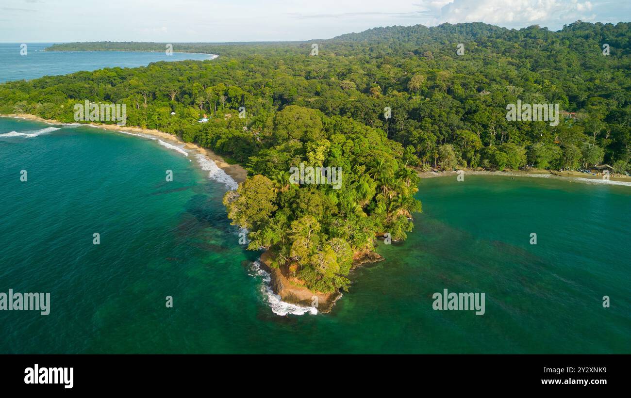 Aerial view of a lush green tropical island surrounded by turquoise ...