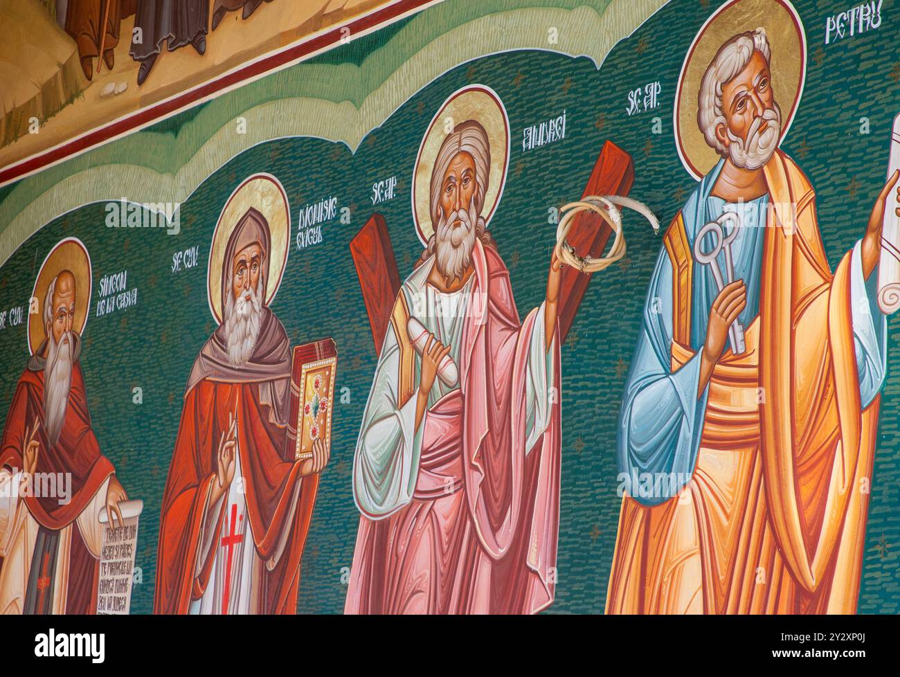A detailed mural depicting religious figures with halos and symbolic ...