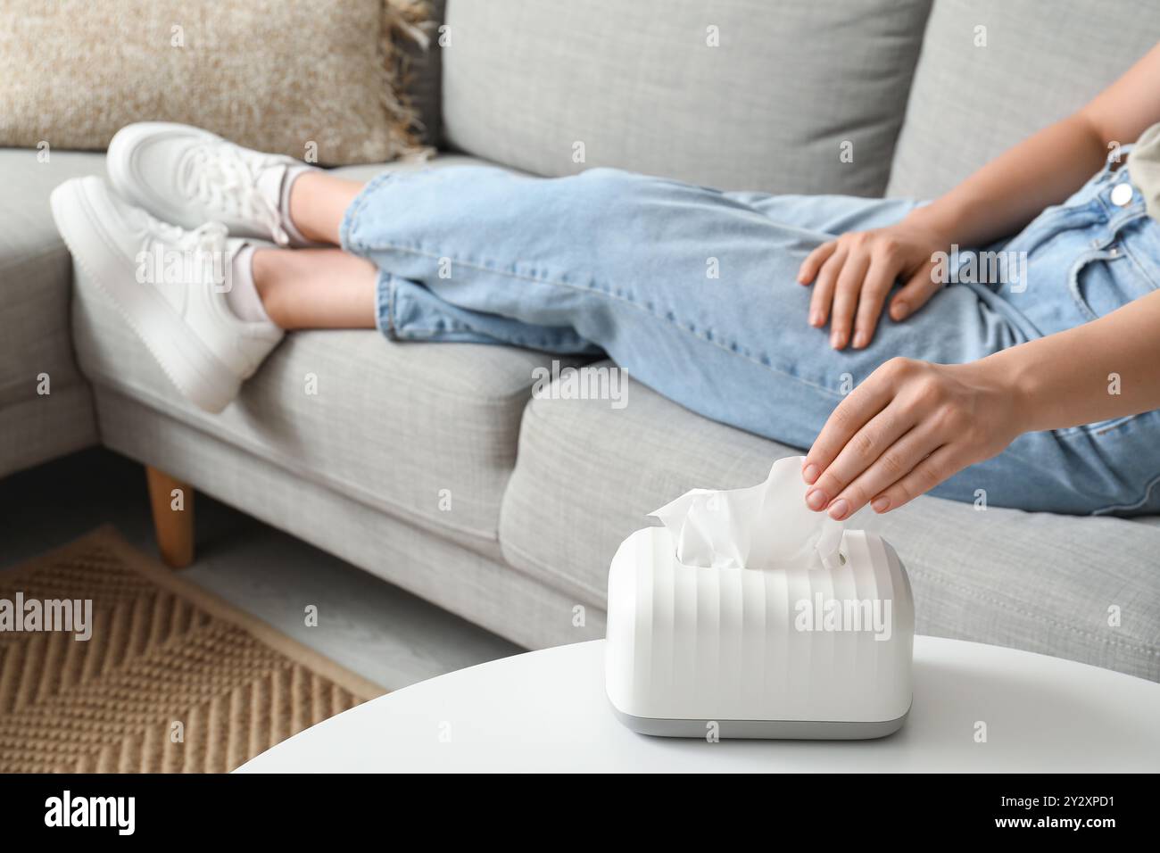 Woman taking tissue from ceramic holder at home Stock Photo - Alamy