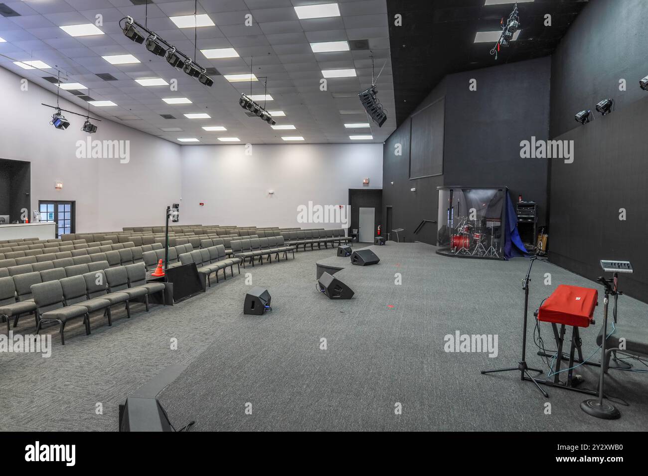 Interior of a modern auditorium with rows of seats, stage, musical ...
