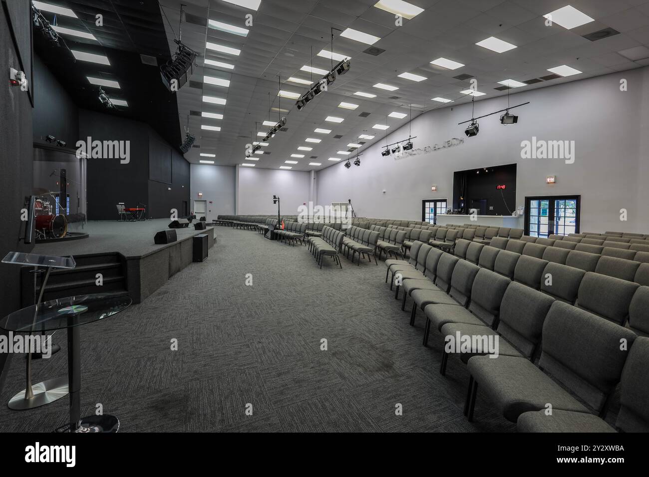 Interior of a modern church auditorium with rows of empty seats and a ...