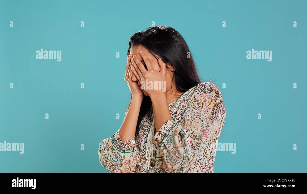 Fearful indian woman covering hi-res stock photography and images - Alamy