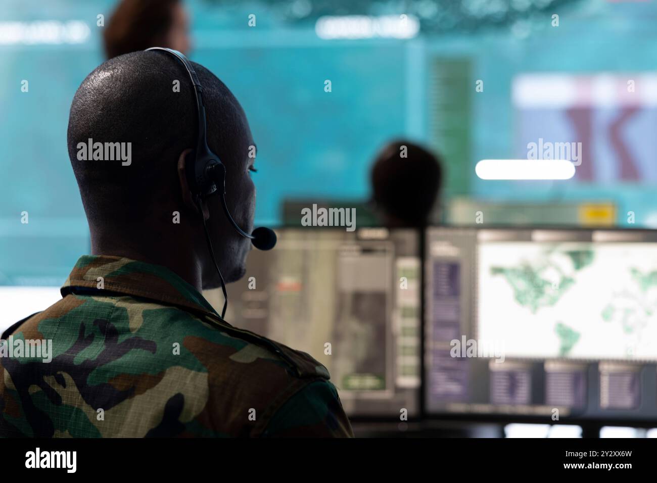 Military personnel operating on CCTV reconnaissance system in command post, gathering ...