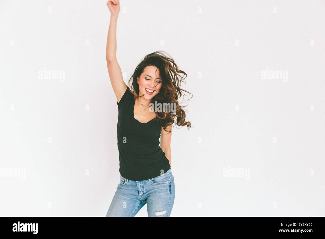 A woman dancing against a plain white background Stock Photo - Alamy