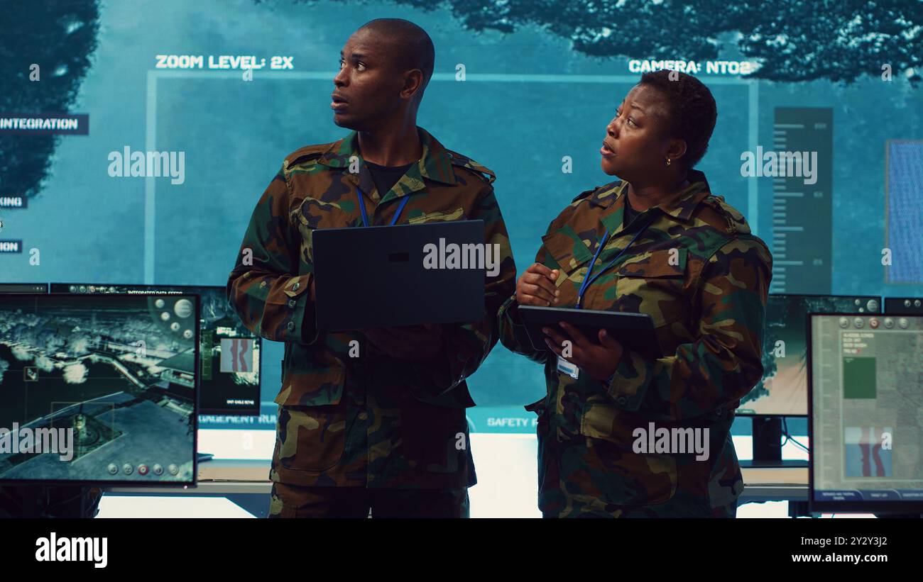 Special operations engineers examining surveillance footage to gather important information for ...