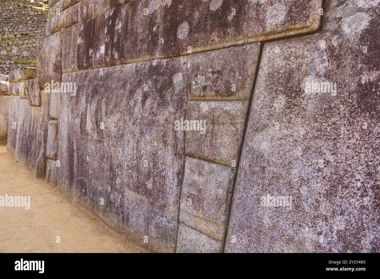 Close-up view of ancient Incan stone wall with precisely cut stones at ...