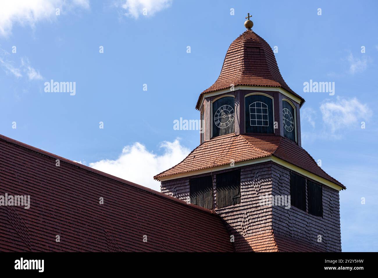 A close-up view of a church steeple with a distinctive dome and clock ...