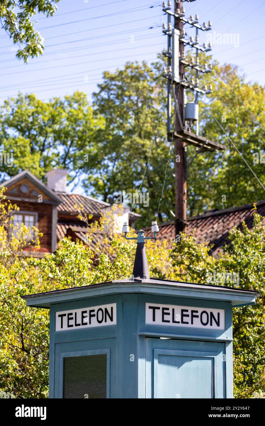 A vintage telephone booth with the word 'TELEFON' displayed prominently ...
