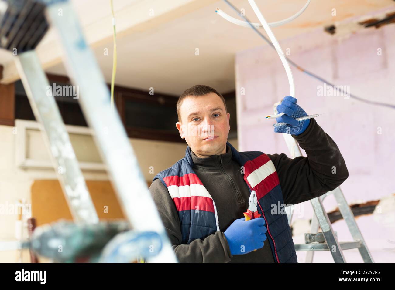 Electrician working with wires in apartment Stock Photo - Alamy