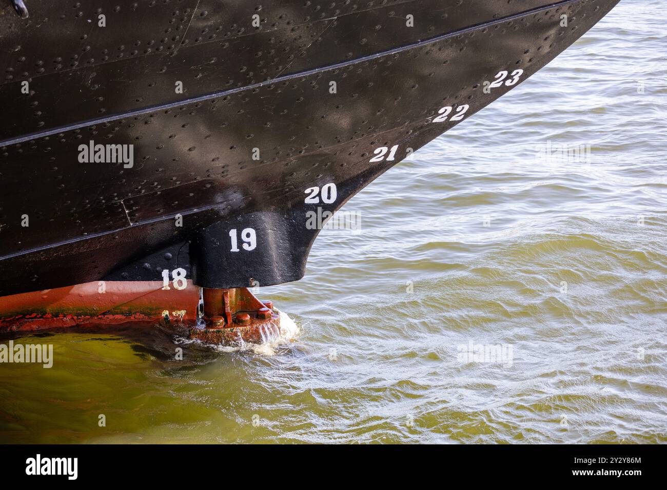 Close-up of a ship's hull with visible numbers indicating draft marks ...