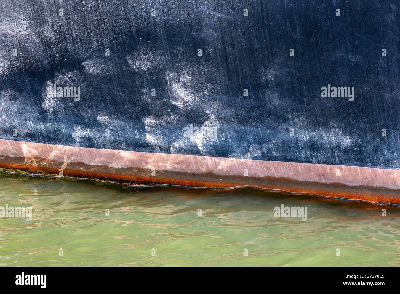 Close-up of a boat's hull showing weathered paint and rust along the ...