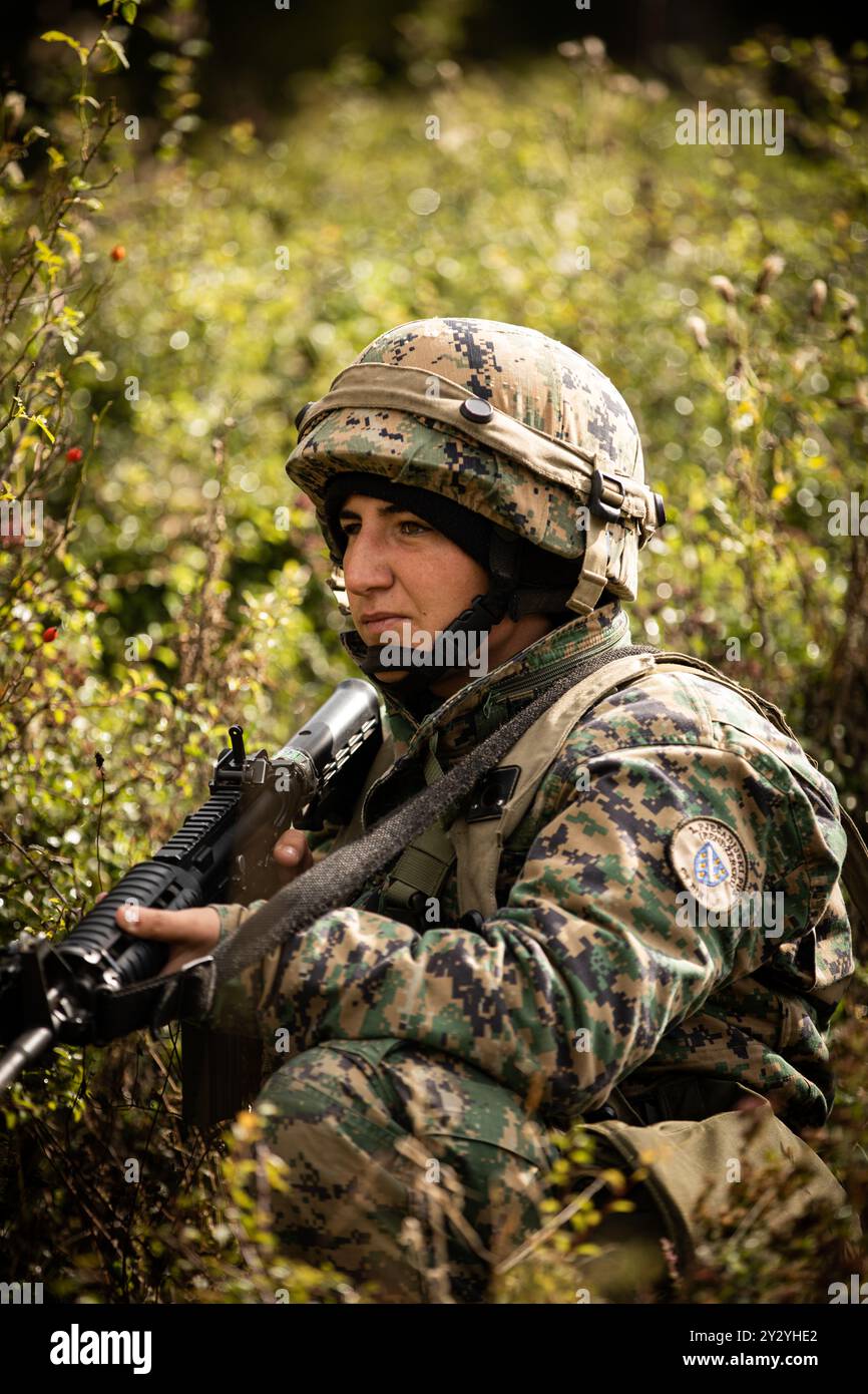A Bosnian soldier holds security of opposing force prisoners during ...