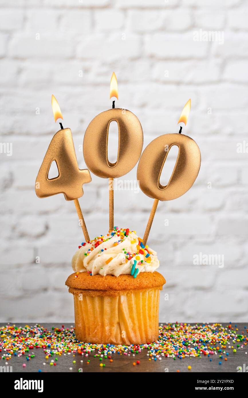 Golden birthday candle number 400 with cupcake - White block wall ...