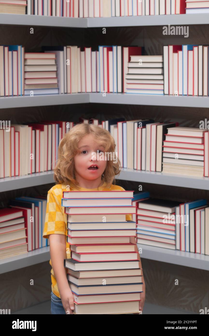 Amazed school kid hold stack of books. Nerd pupil. Back to school ...