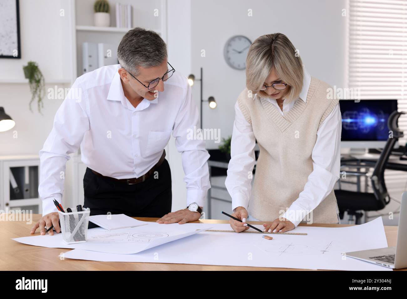 Architects making engineering drawing at wooden table in office Stock ...