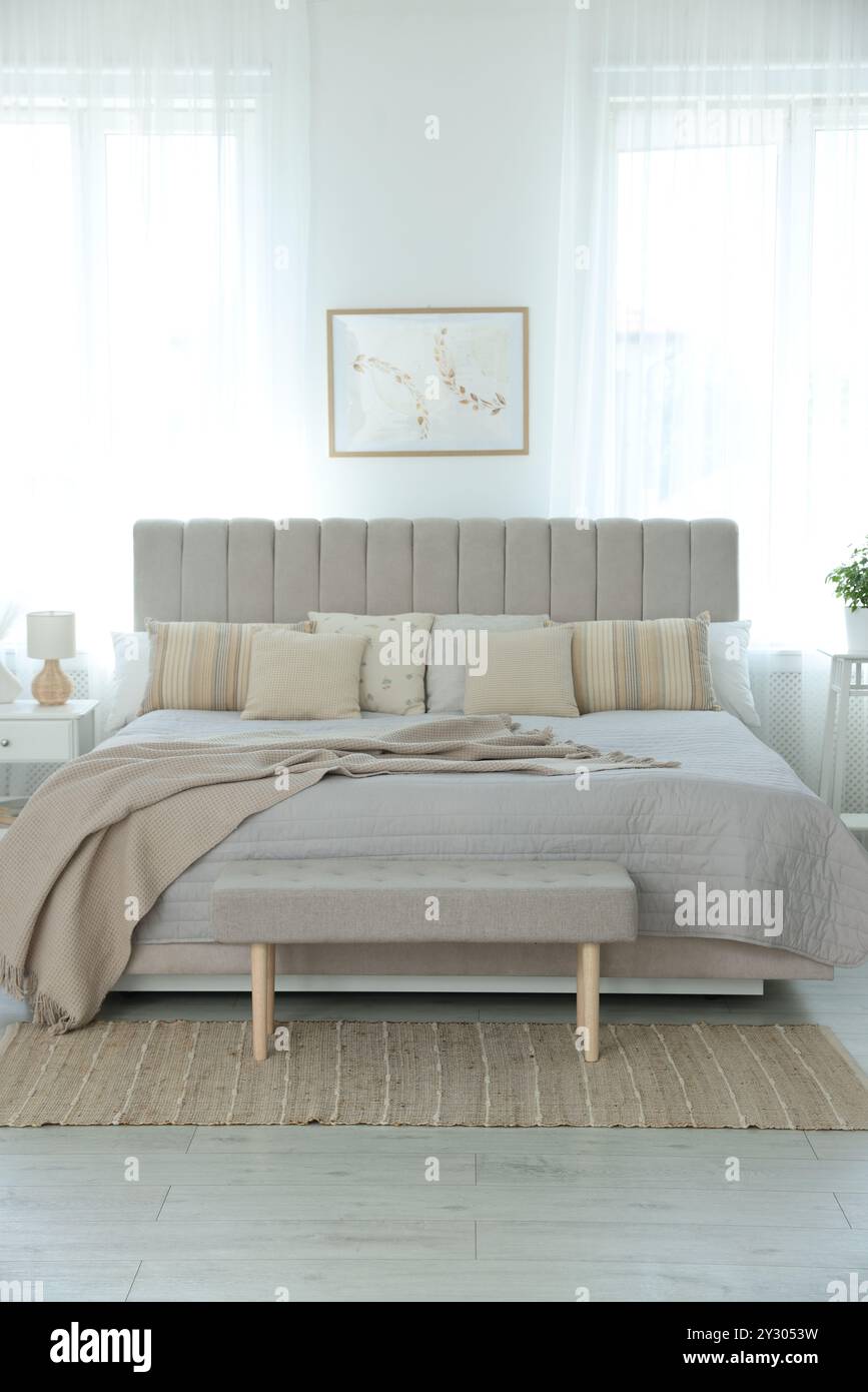 Big comfortable bed in room. Interior design Stock Photo - Alamy