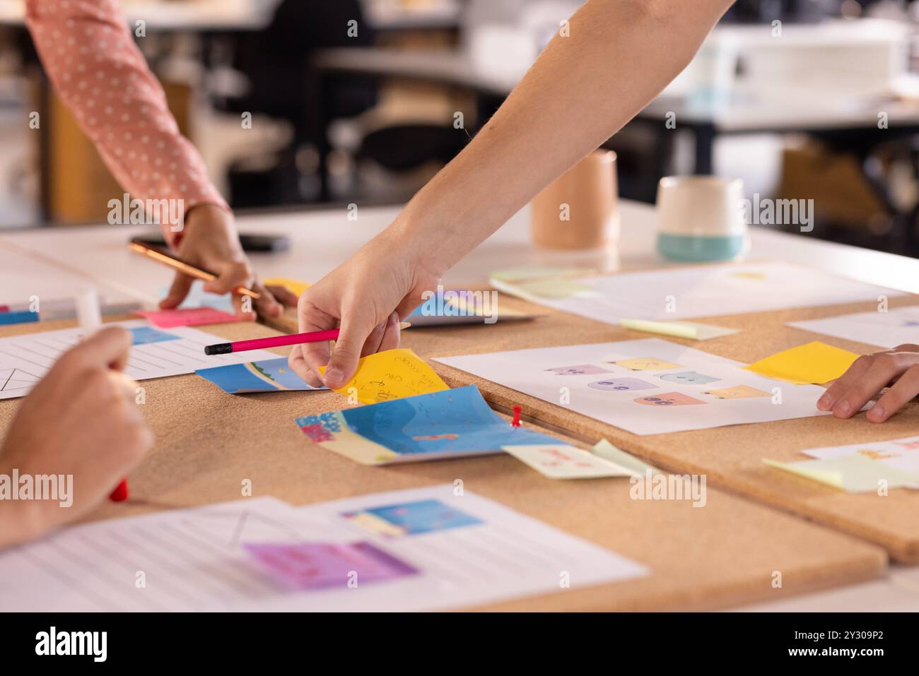 At office, Collaborating on creative writing, multiracial women ...